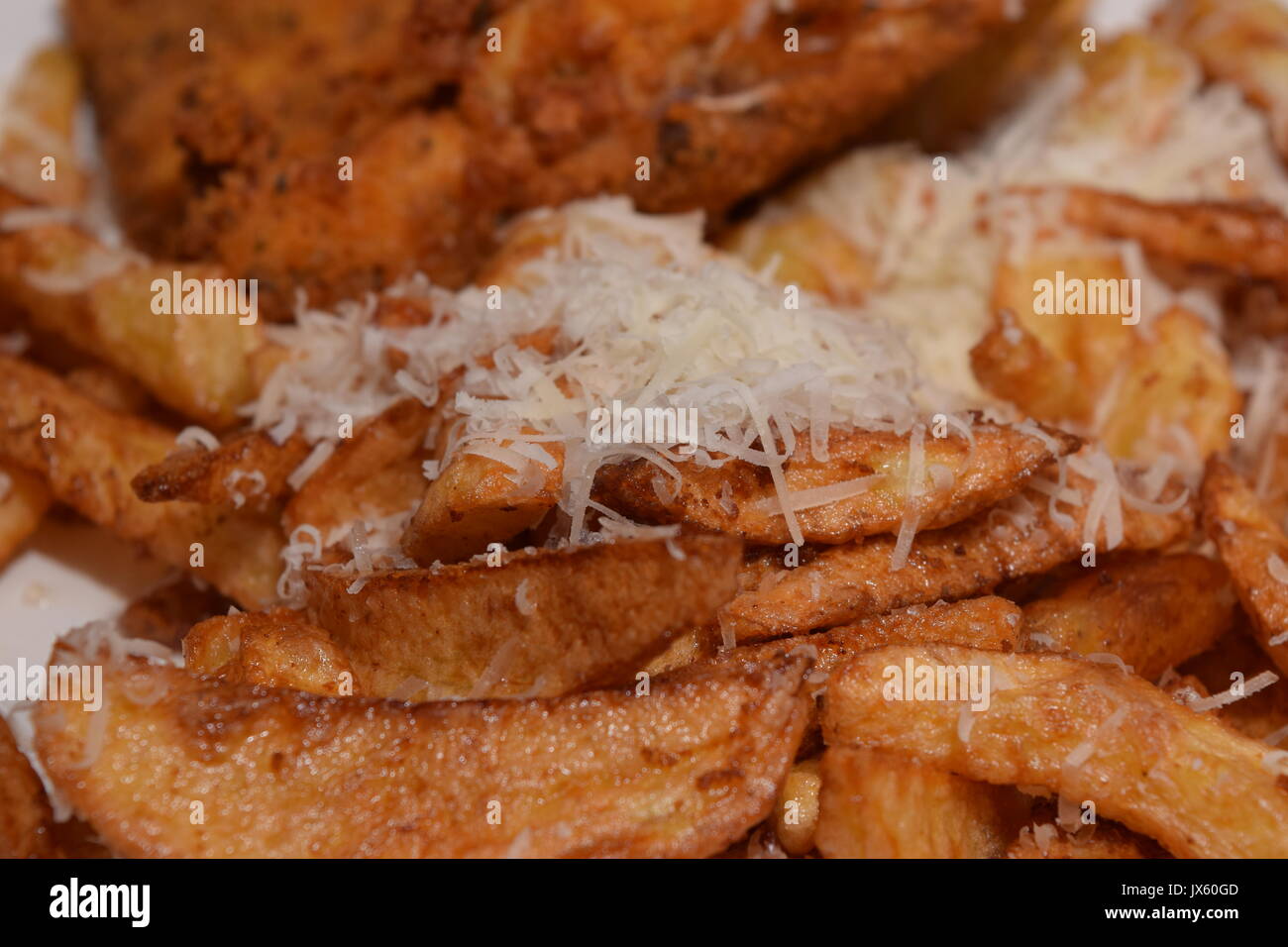 Close up of fish and cheesy chips Stock Photo - Alamy
