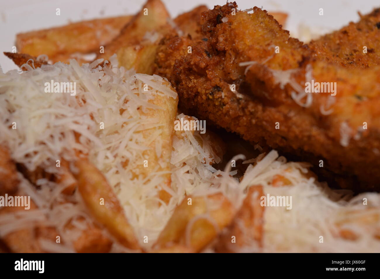 Close up of fish and cheesy chips Stock Photo - Alamy
