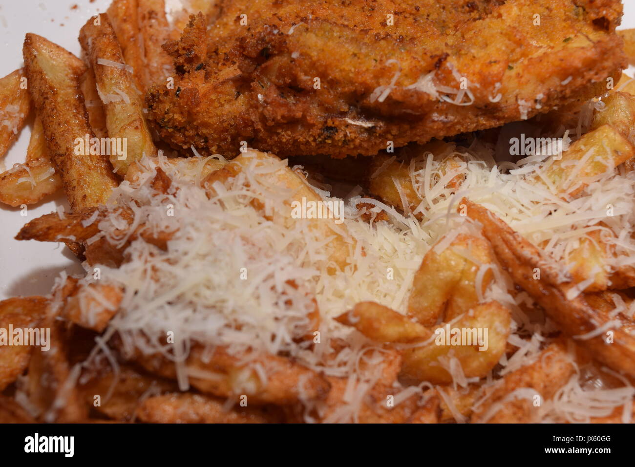 Close up of fish and cheesy chips Stock Photo - Alamy