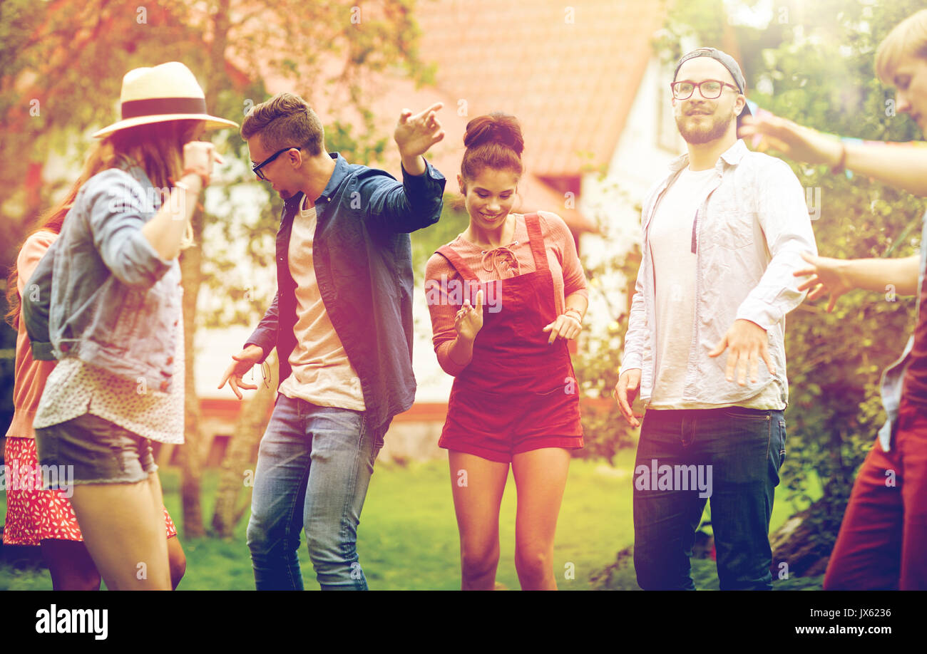 happy friends dancing at summer party in garden Stock Photo - Alamy