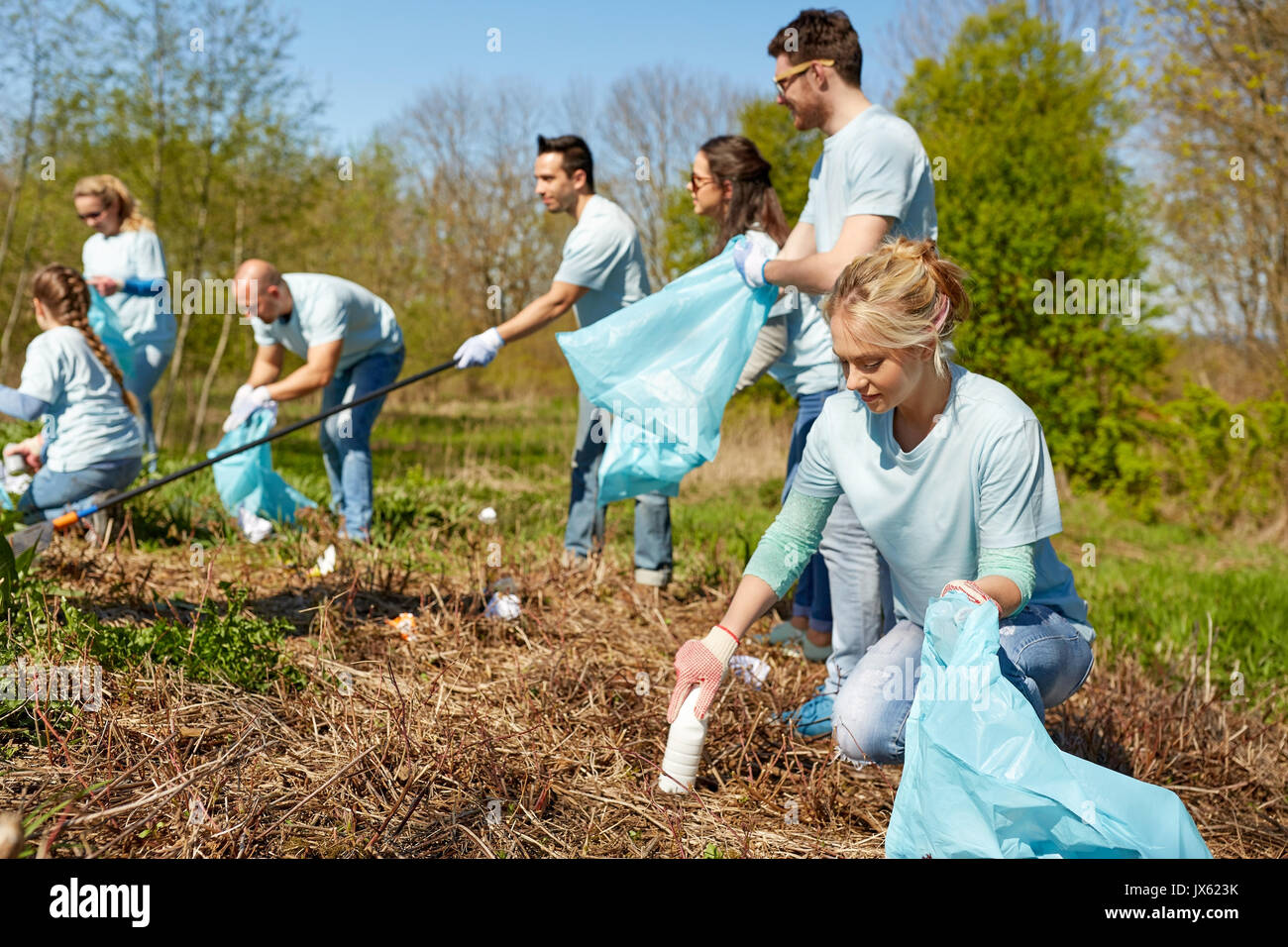 volunteers with garbage bags cleaning park area Stock Photo - Alamy