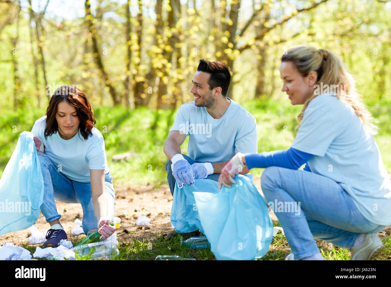 volunteers with garbage bags cleaning park area Stock Photo - Alamy