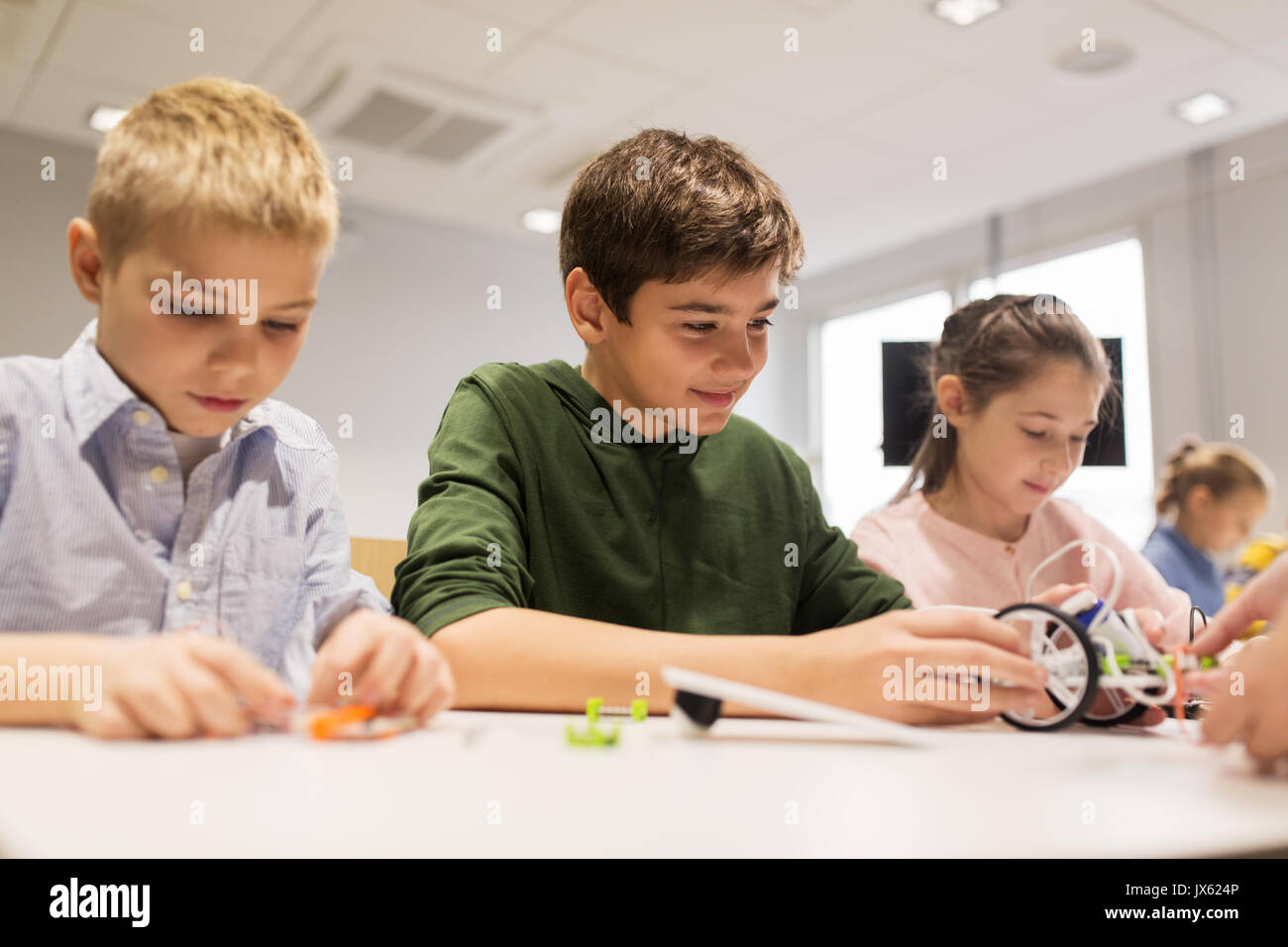 happy children building robots at robotics school Stock Photo - Alamy