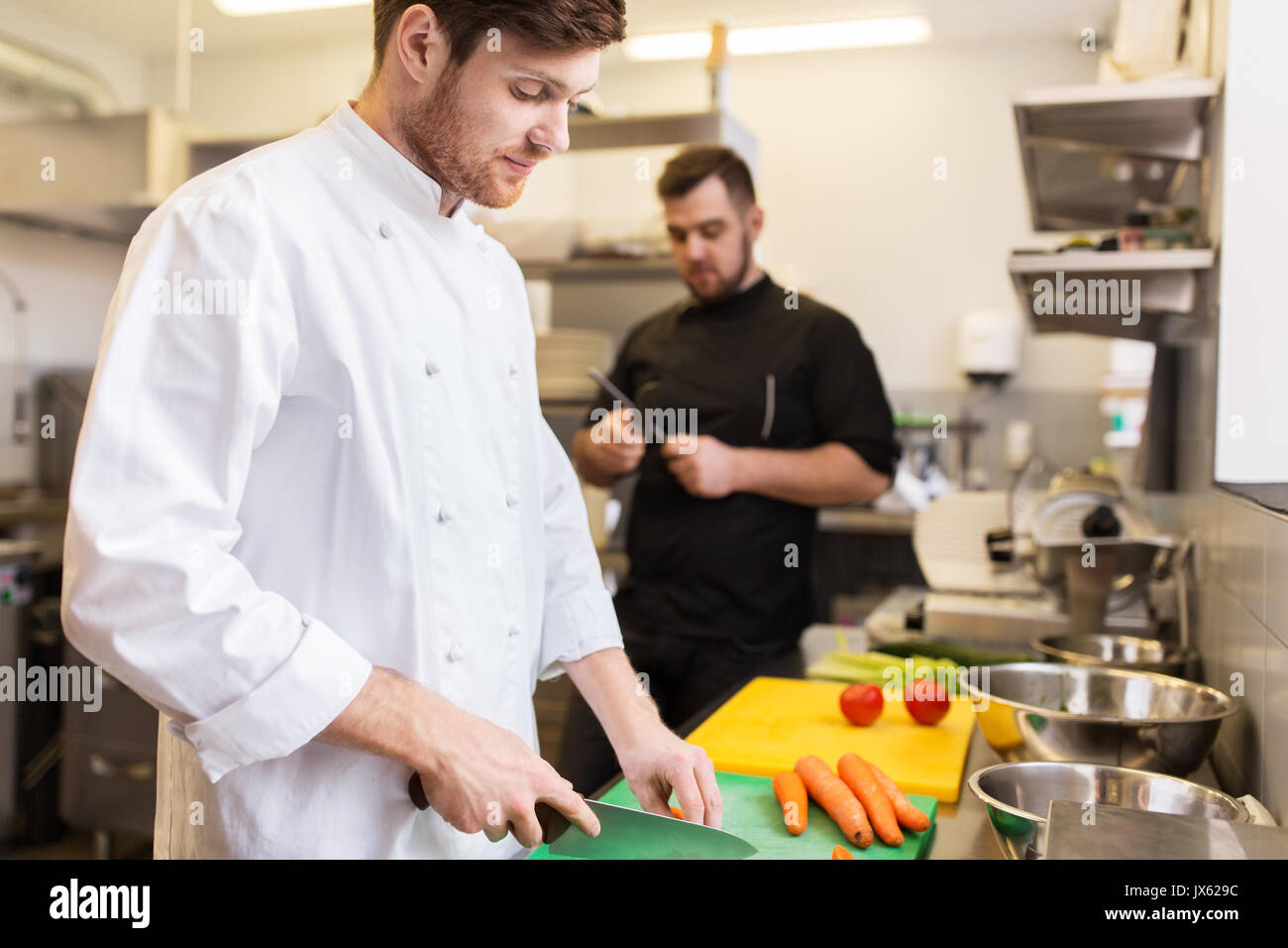 chef and cook cooking food at restaurant kitchen Stock Photo - Alamy