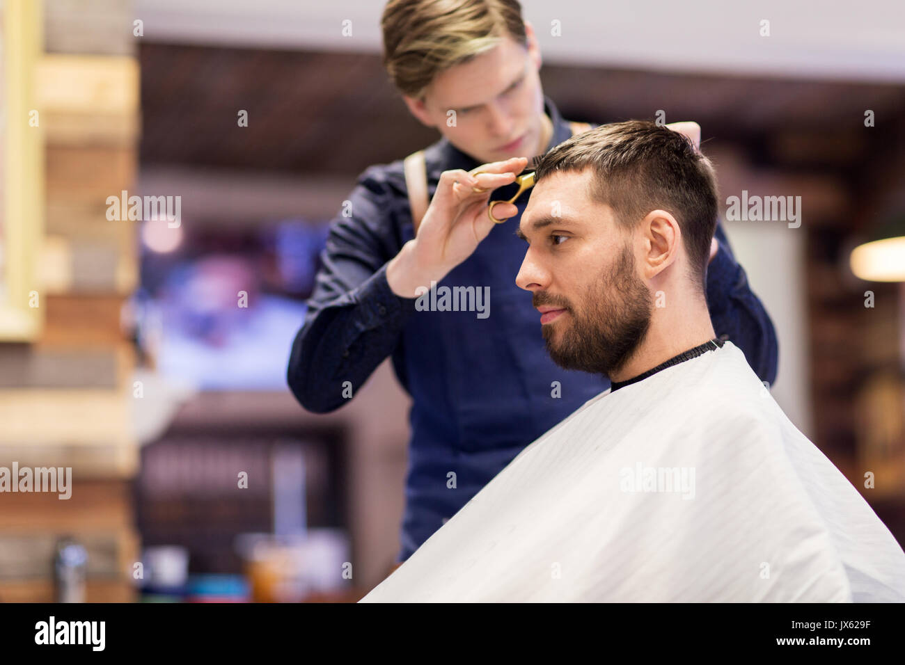 man and barber cutting hair at barbershop Stock Photo - Alamy
