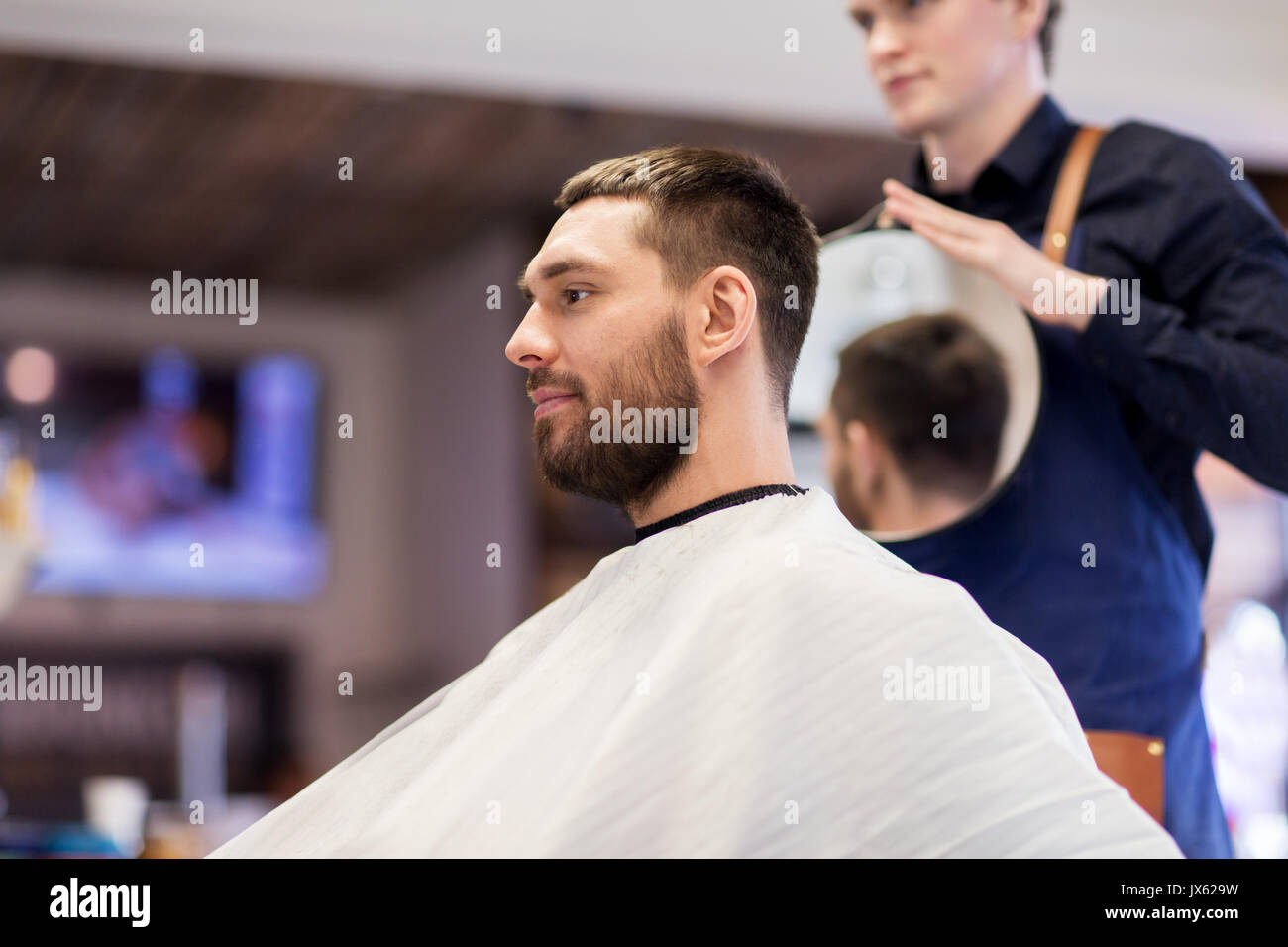 man and hairdresser with mirror at barbershop Stock Photo - Alamy