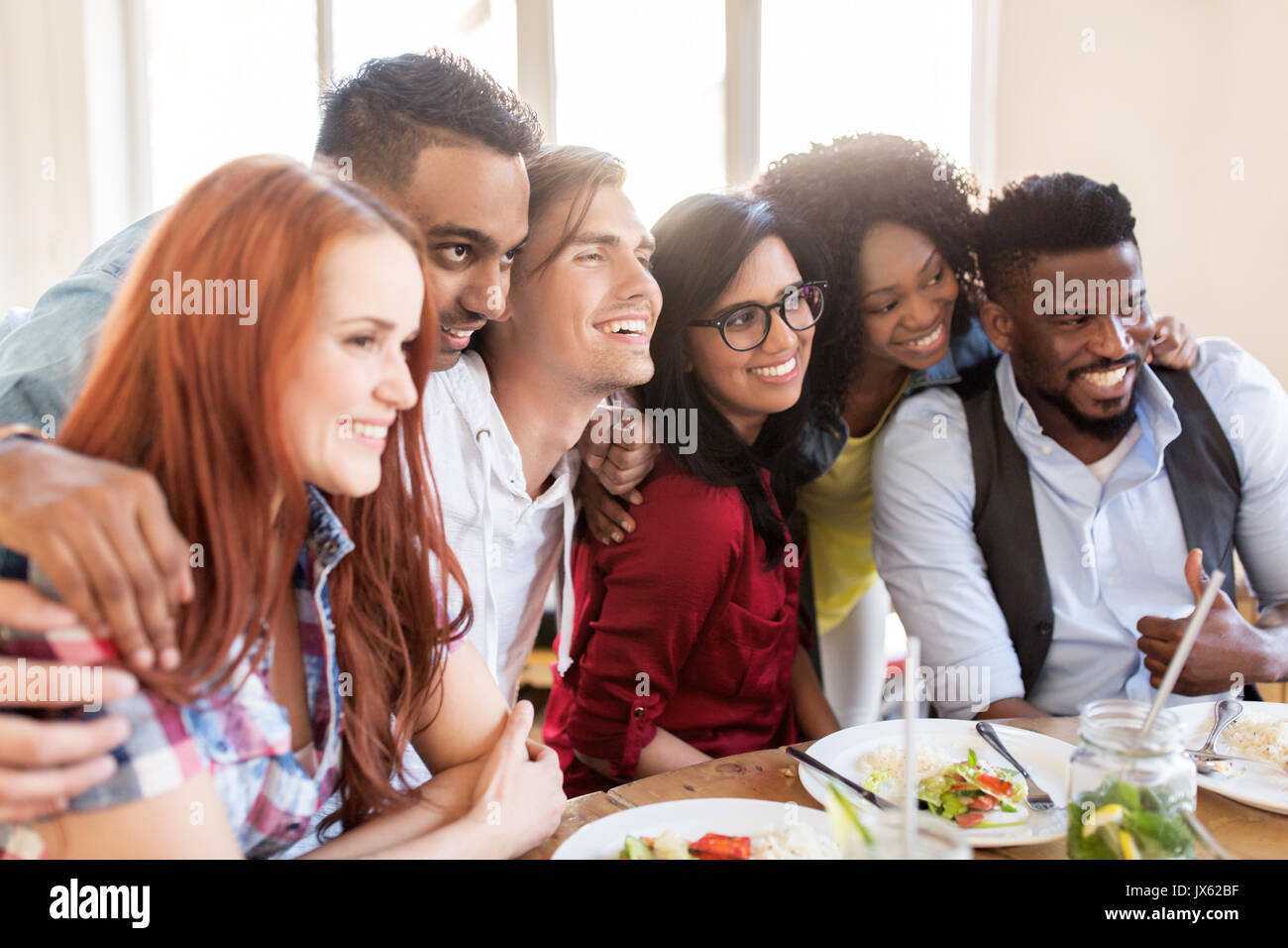 happy friends eating at restaurant Stock Photo - Alamy
