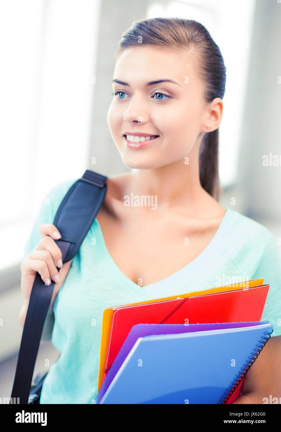 student girl with school bag and color folders Stock Photo - Alamy