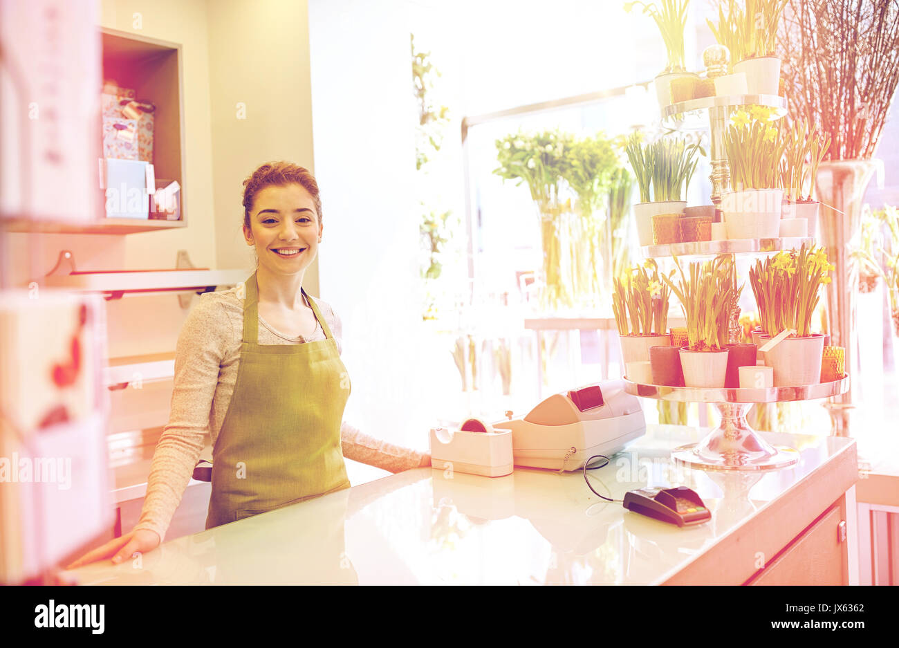 happy smiling florist woman at flower shop counter Stock Photo - Alamy