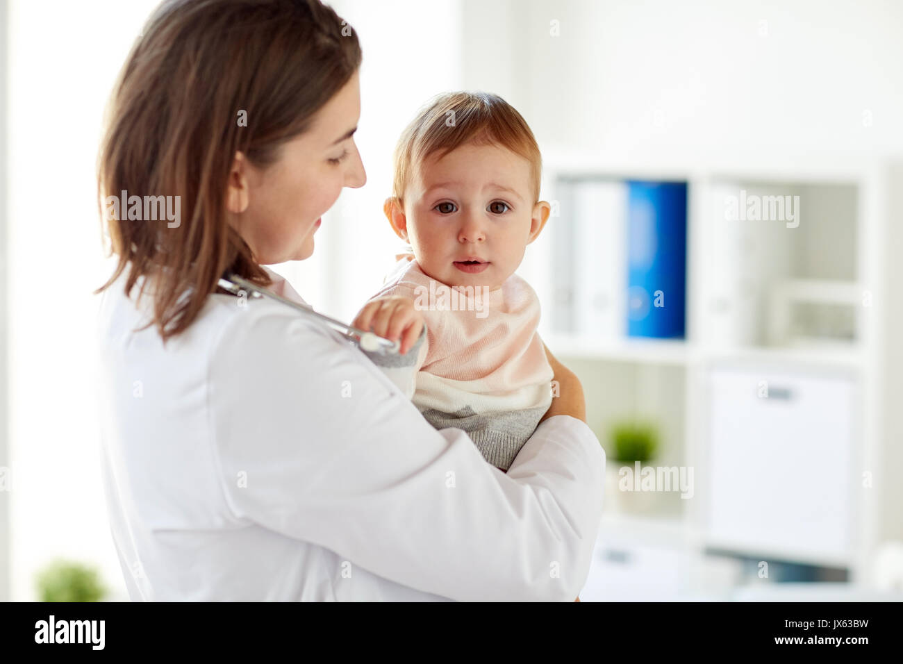 happy doctor or pediatrician with baby at clinic Stock Photo - Alamy
