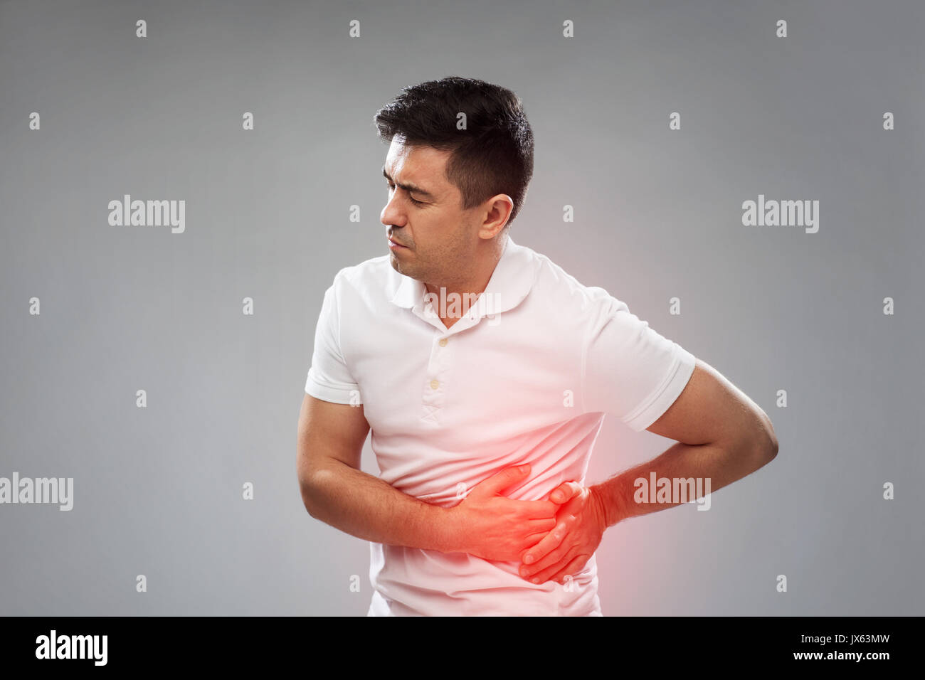 unhappy man suffering from stomach ache Stock Photo - Alamy