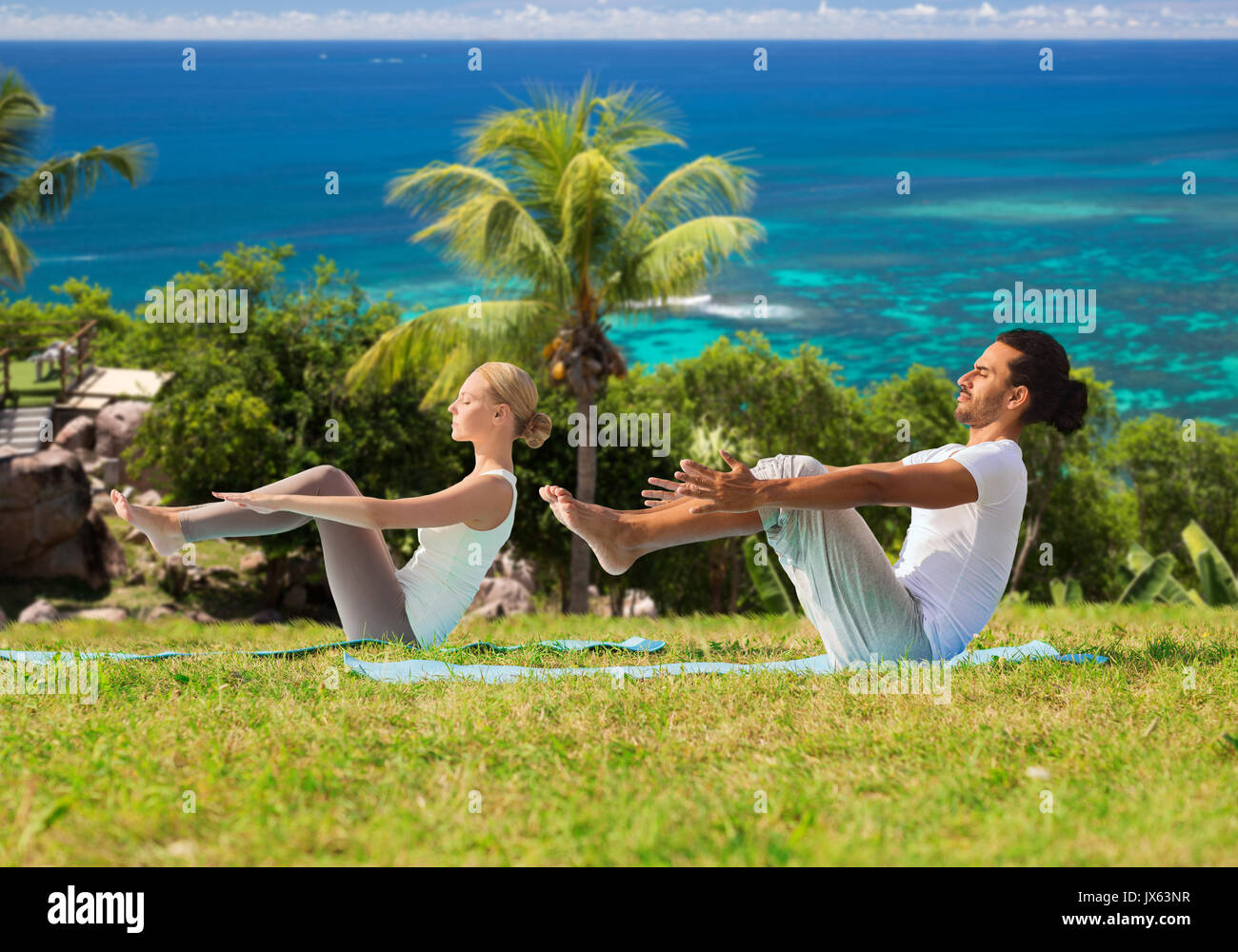 couple making yoga half-boat pose outdoors Stock Photo - Alamy