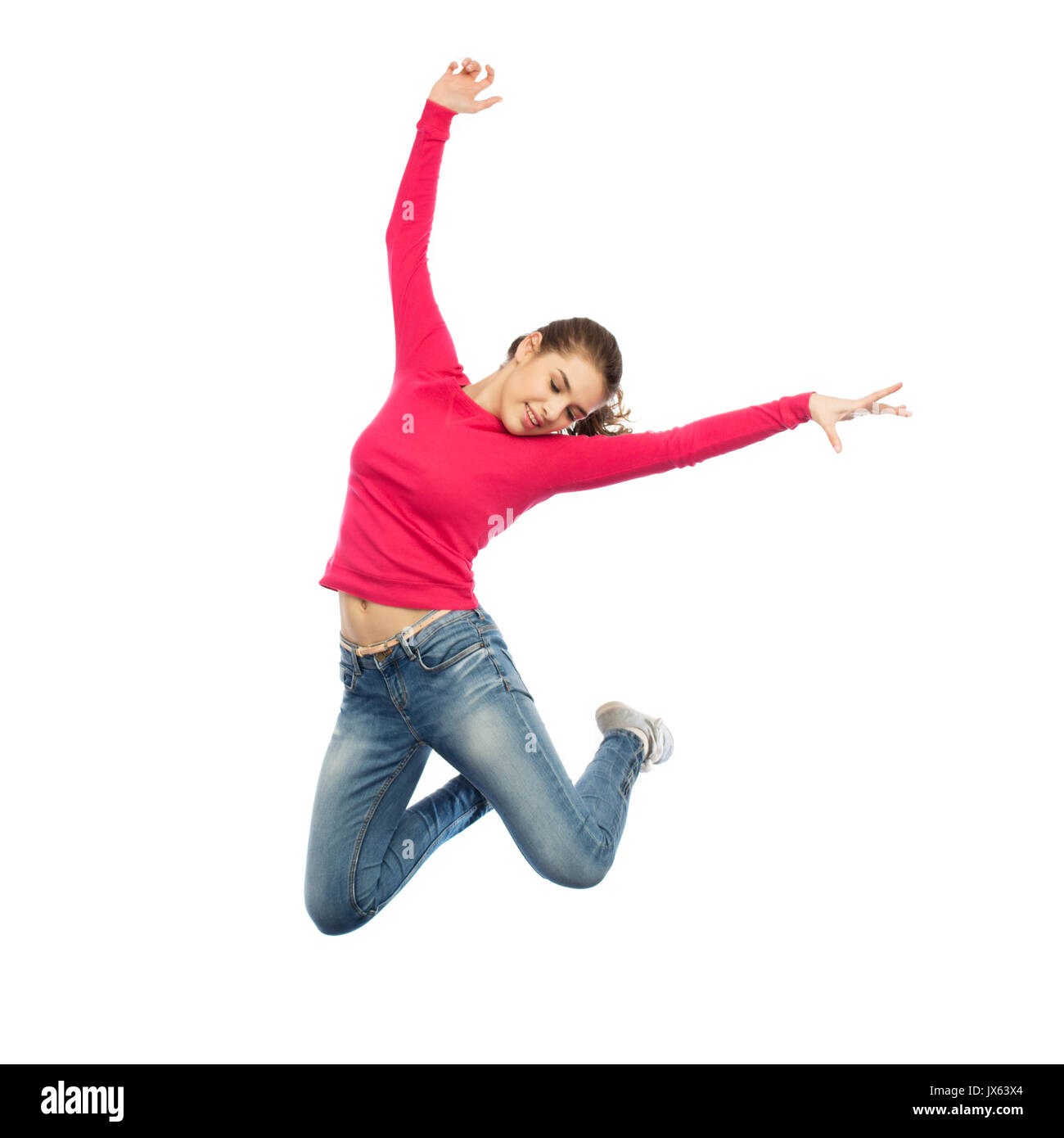 happy young woman jumping in air or dancing Stock Photo - Alamy