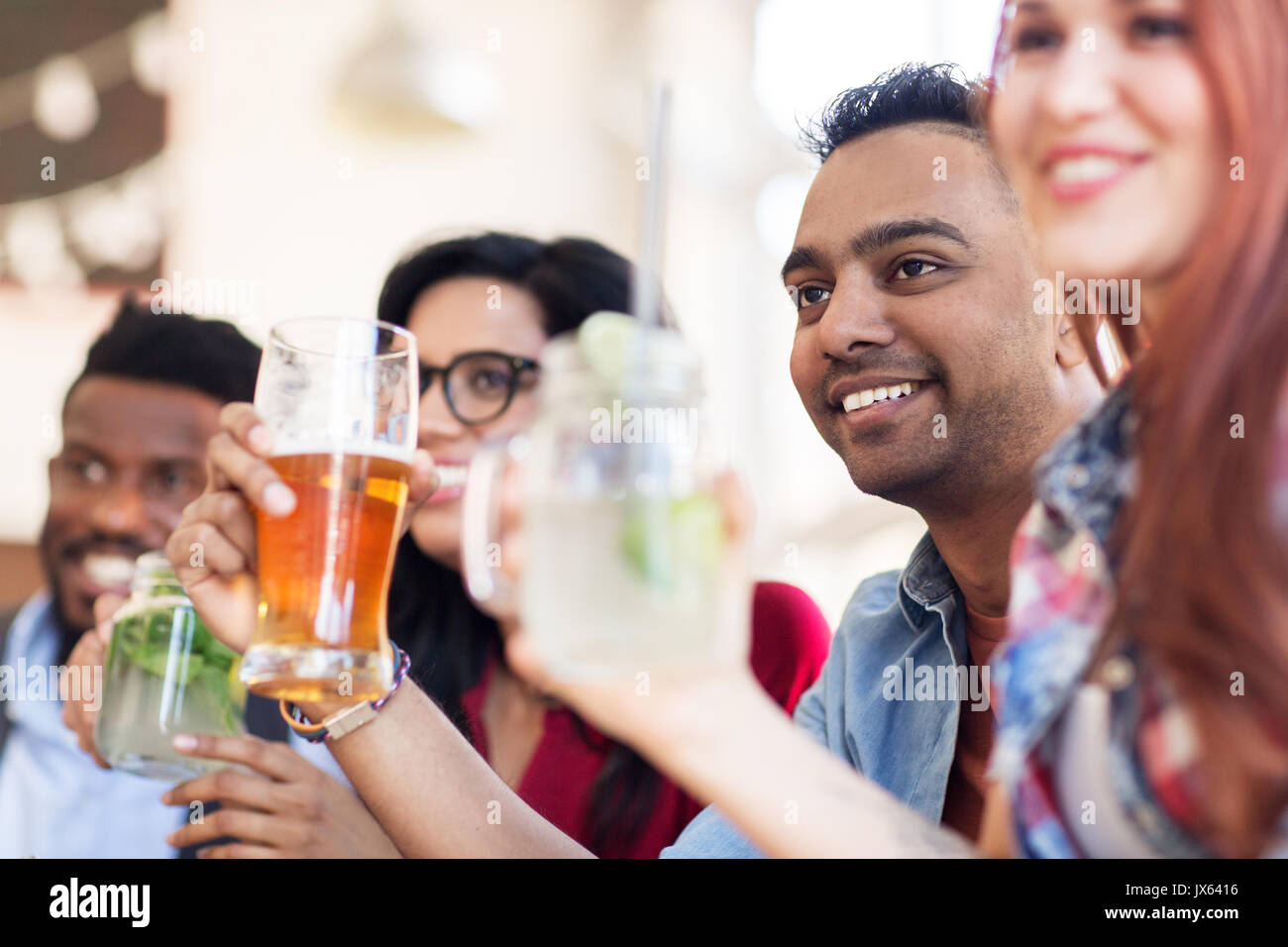 happy friends with drinks at restaurant Stock Photo - Alamy