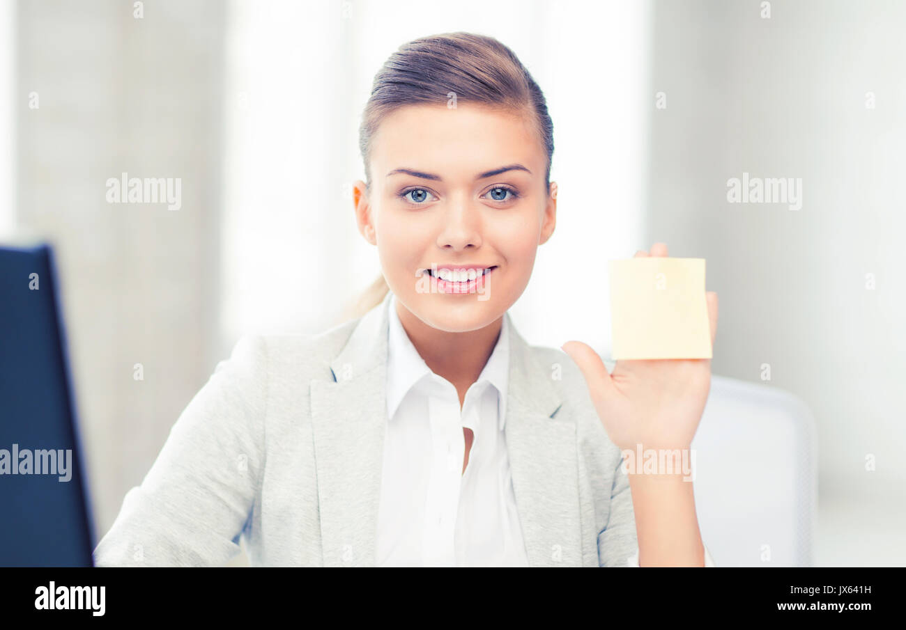 smiling businesswoman showing sticky note Stock Photo - Alamy
