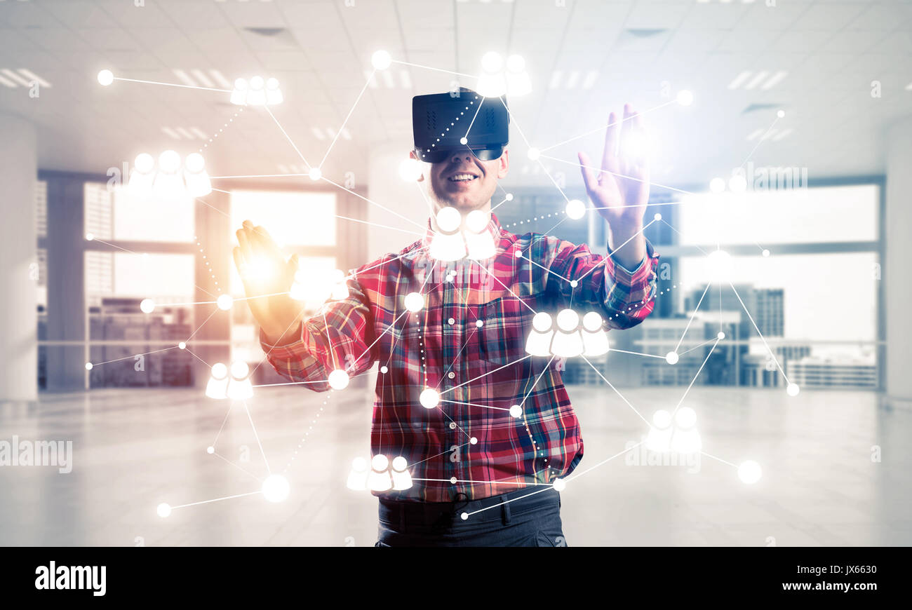 Guy wearing checked shirt and virtual mask reaching hand to touc Stock ...