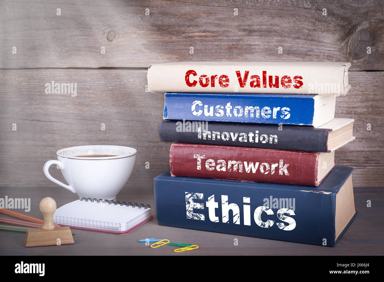 Core Values concept. Stack of books on wooden desk Stock Photo - Alamy