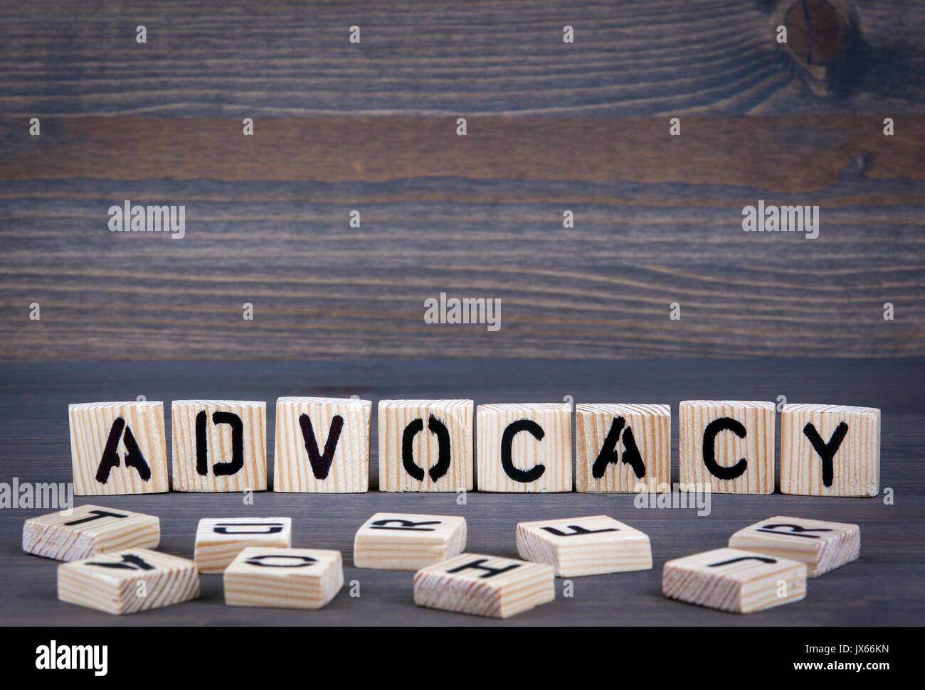 Advocacy word written on wood block. Dark wood background with texture ...