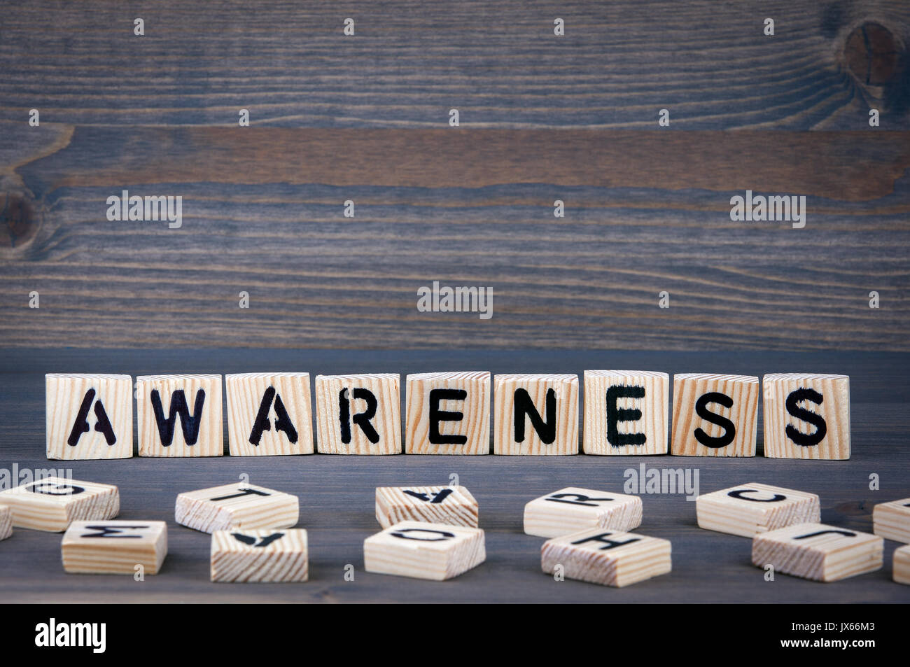 Awareness word written on wood block. Dark wood background with texture ...
