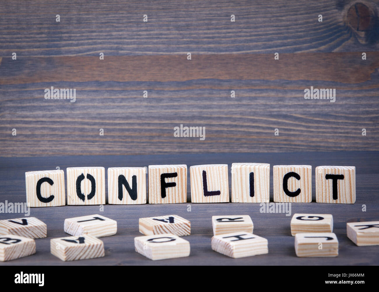 Conflict word written on wood block. Dark wood background with texture ...
