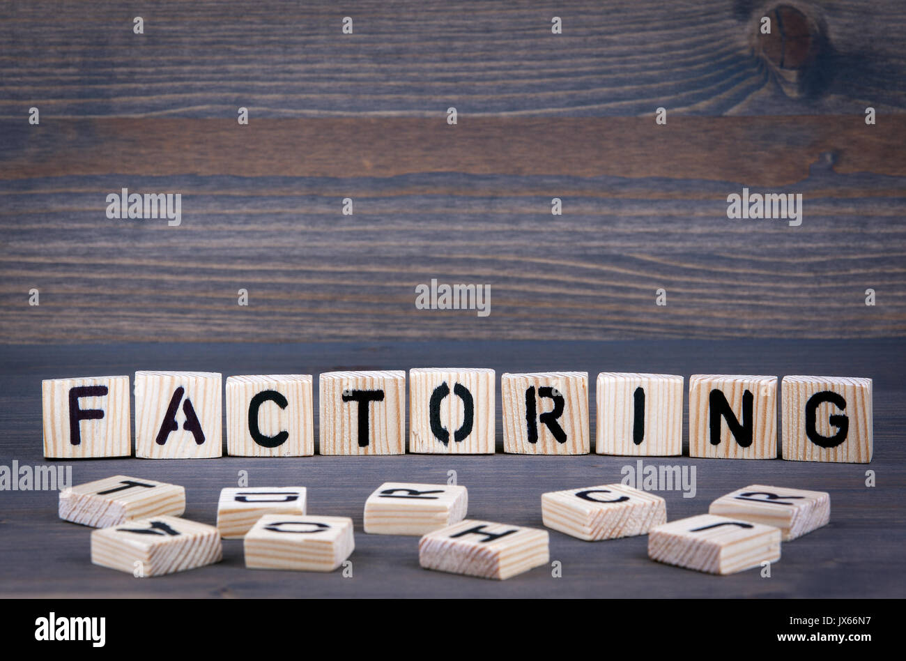 Factoring word written on wood block. Dark wood background with texture ...
