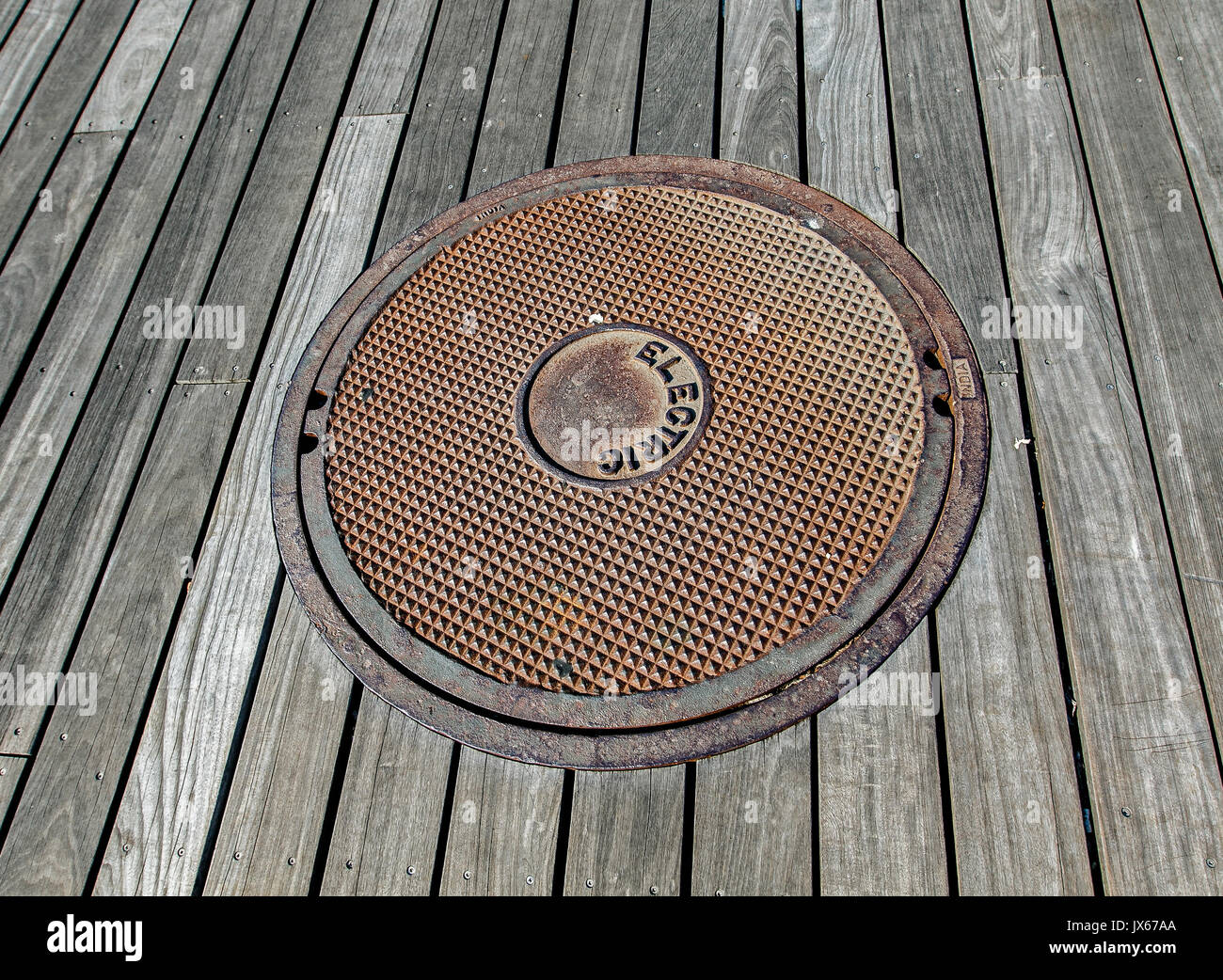 Round manhole lid covering an access point to electrical Stock Photo ...