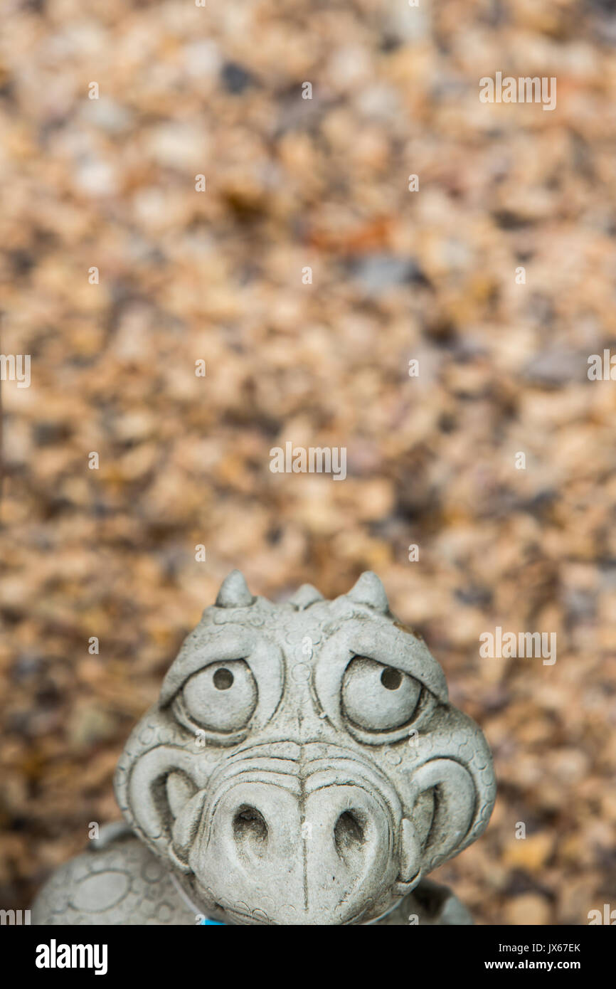 Cheeky stone baby dragon face Stock Photo - Alamy