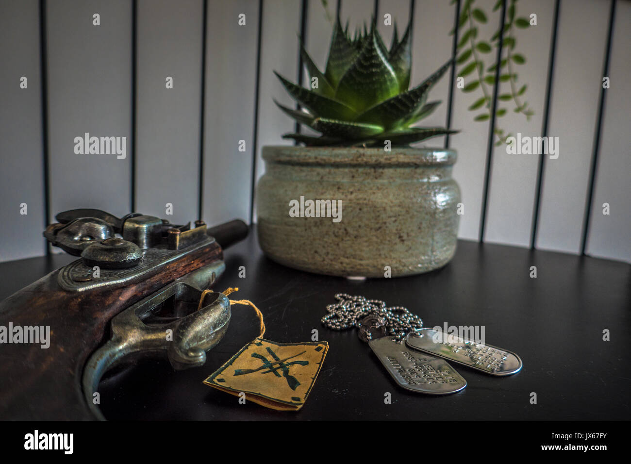 Pistol, tags and cactus Stock Photo - Alamy