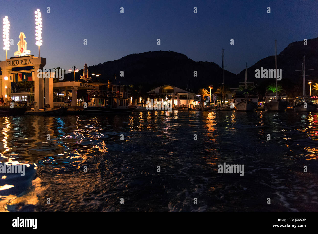 Small city and harbor at night. Sea and lights. Clear sky in Turkey ...