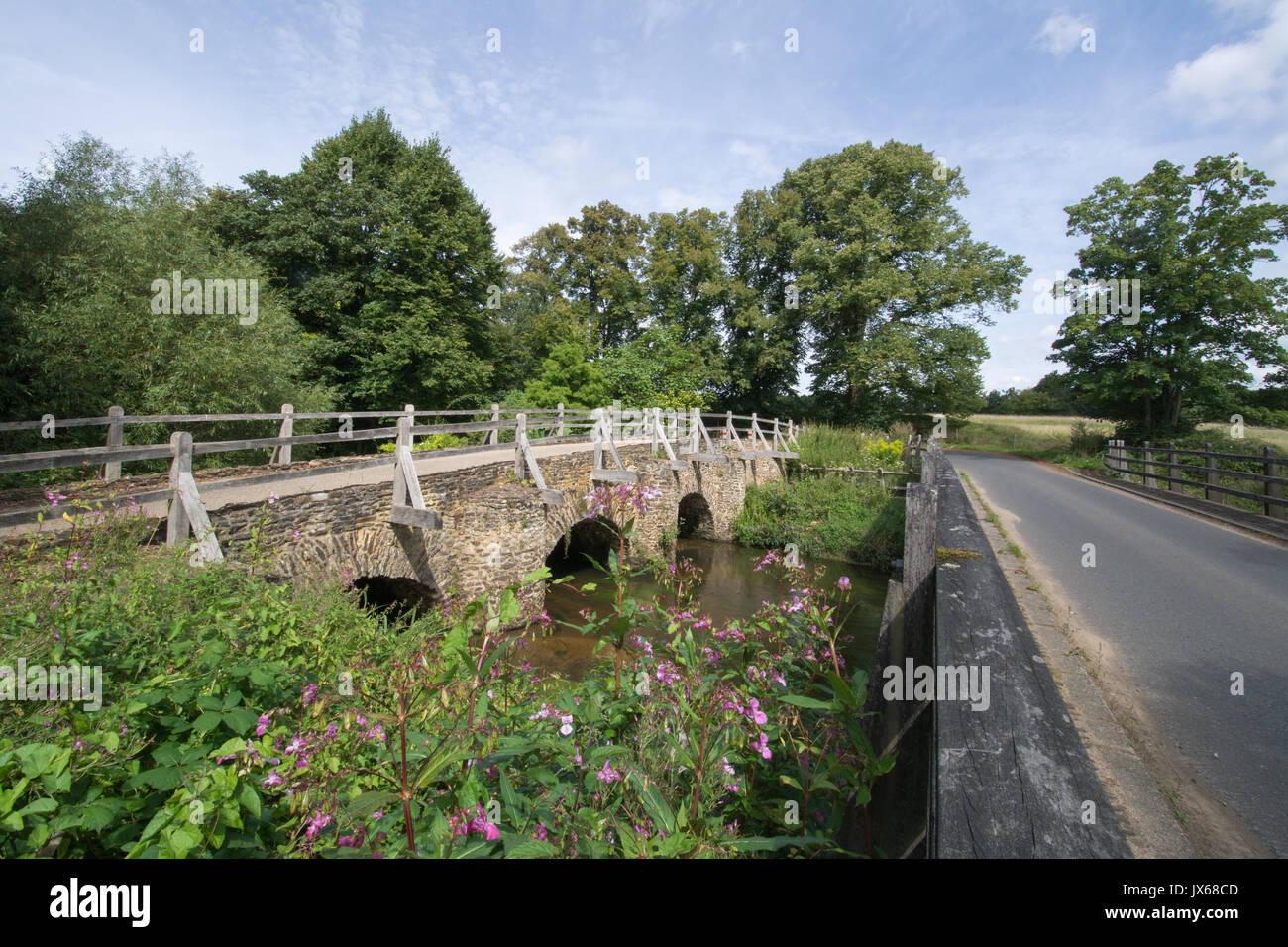Medieval bridge over the River Wey at Tilford village in Surrey, UK ...