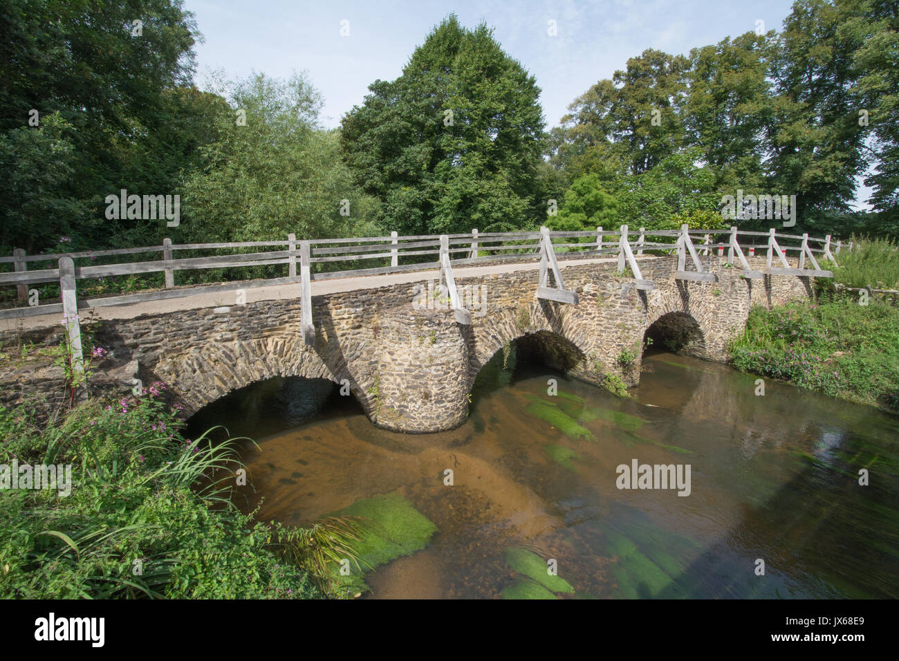 Medieval bridge over the River Wey at Tilford village in Surrey, UK ...