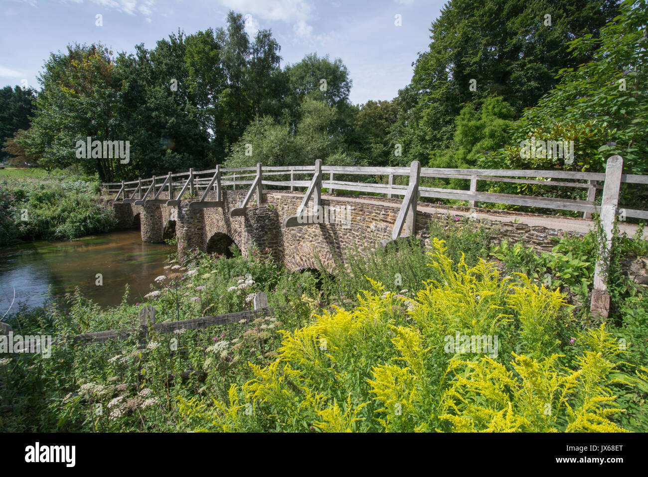 Medieval bridge over the River Wey at Tilford village in Surrey, UK ...