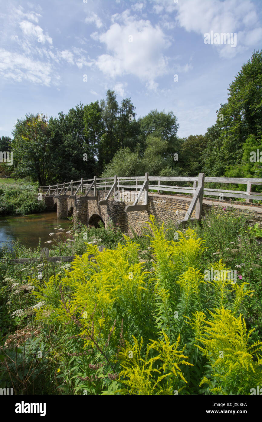 Medieval bridge over the River Wey at Tilford village in Surrey, UK ...