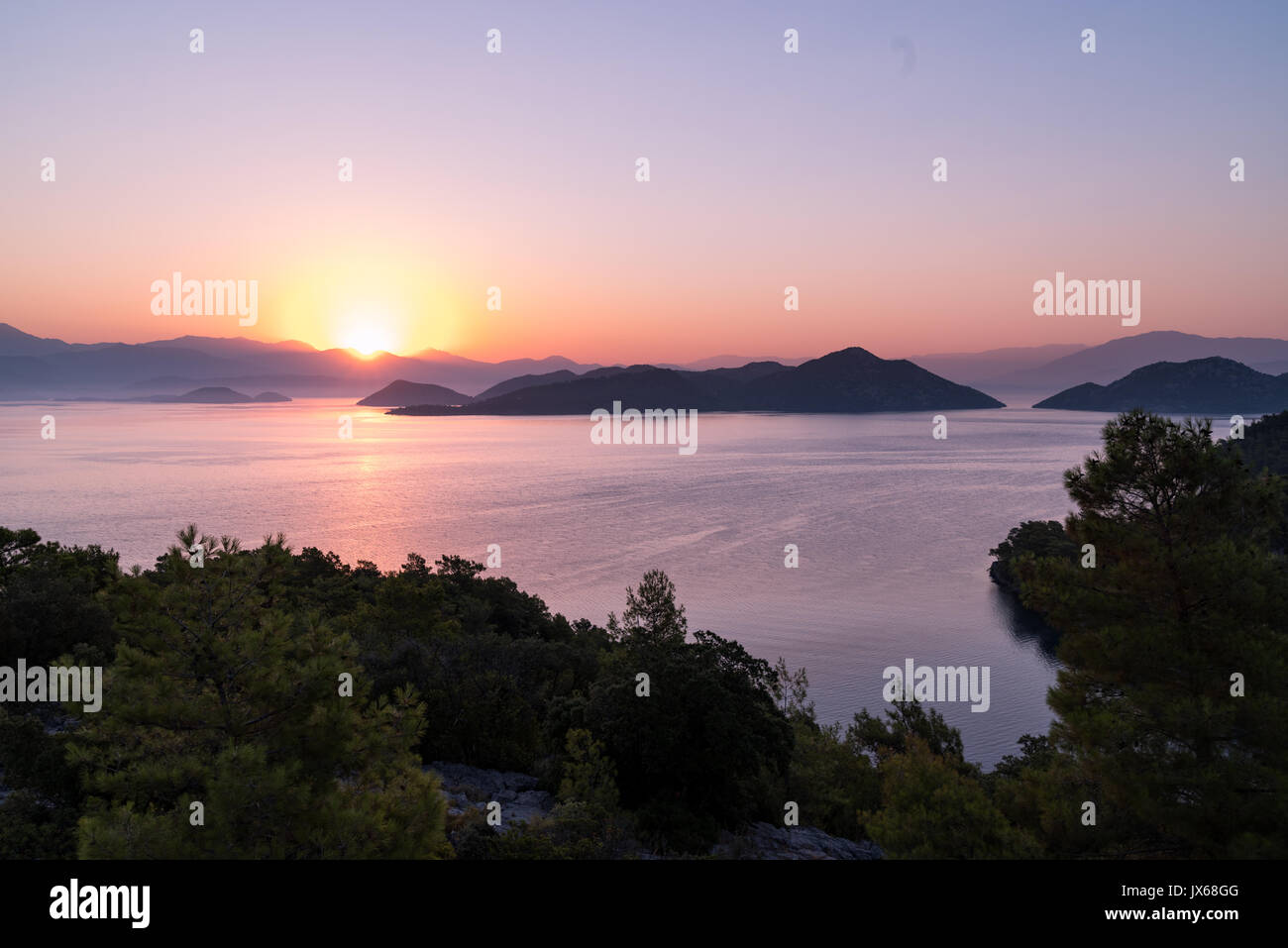 Sunrise over bay in Turkey with calm light and still water. Mountains ...
