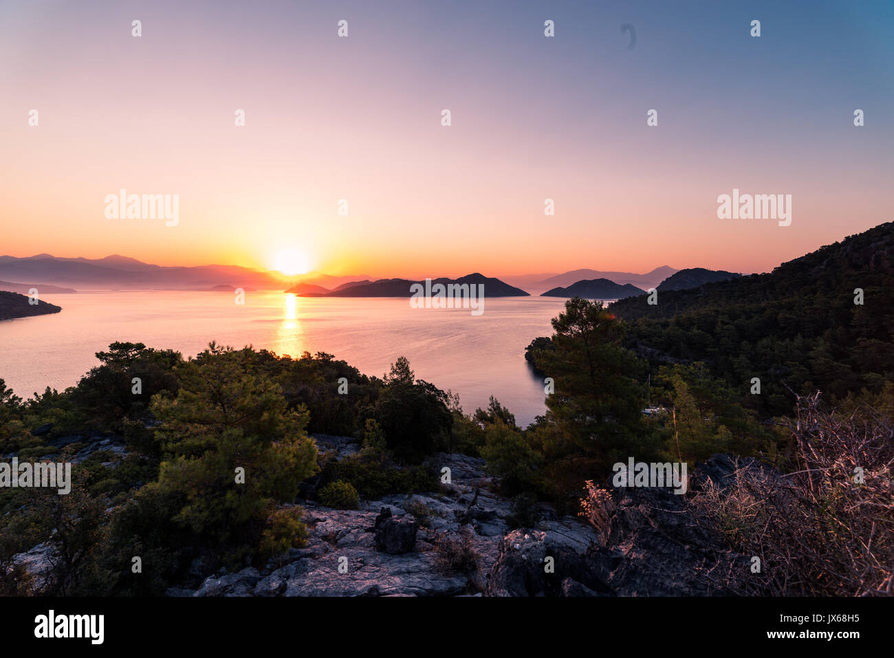Sunrise over bay in Turkey with calm light and still water. Mountains ...
