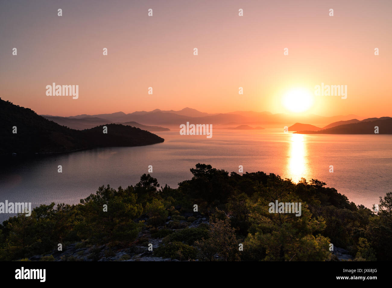 Sunrise over bay in Turkey with calm light and still water. Mountains ...