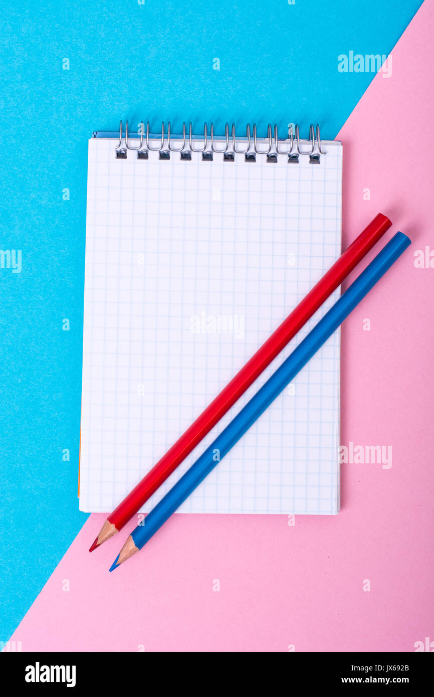 Notepad for notes and colorful pencils on colored background. Studio ...