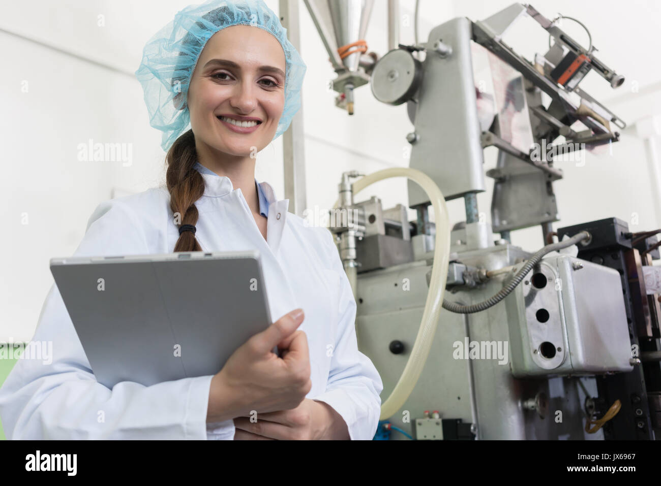 Portrait of quality control inspector smiling during inspection Stock ...
