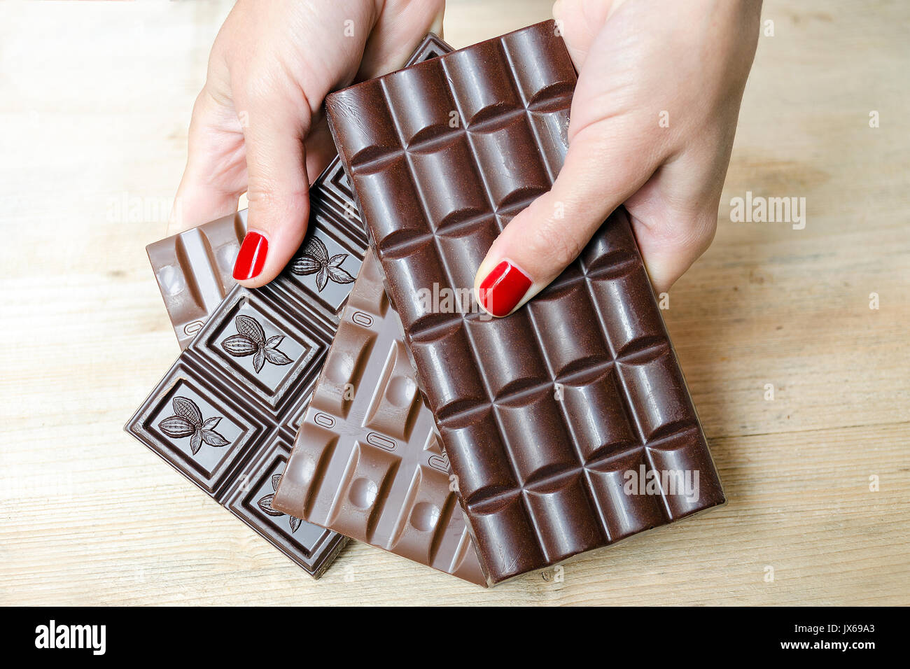Women's hands, offering a choice of different chocolate bars - black ...