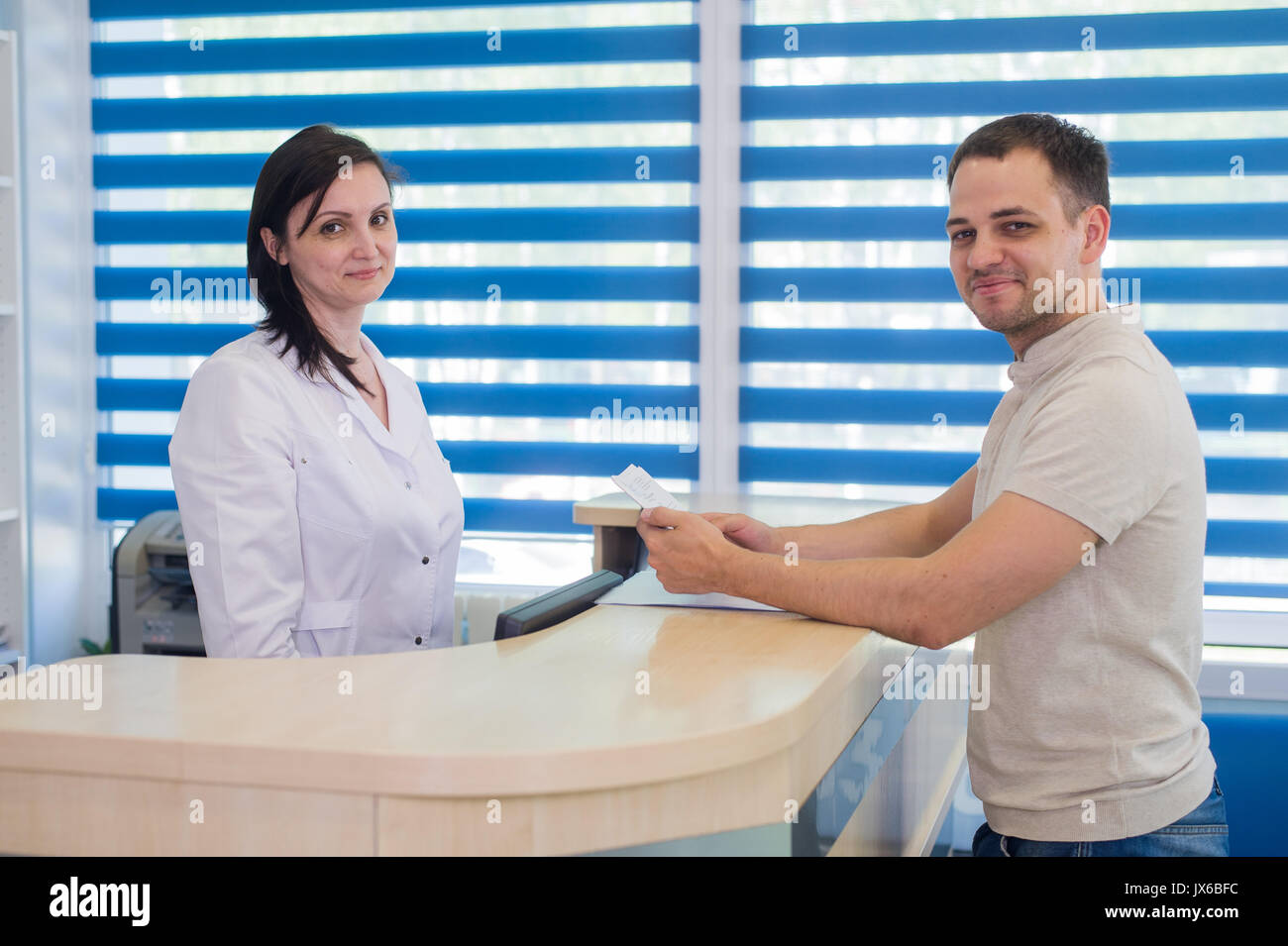 Receptionist giving medical insurance hi-res stock photography and ...