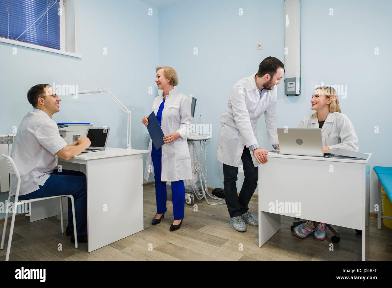 Group Of Doctors Involved In Serious Discussion With Medical Records ...