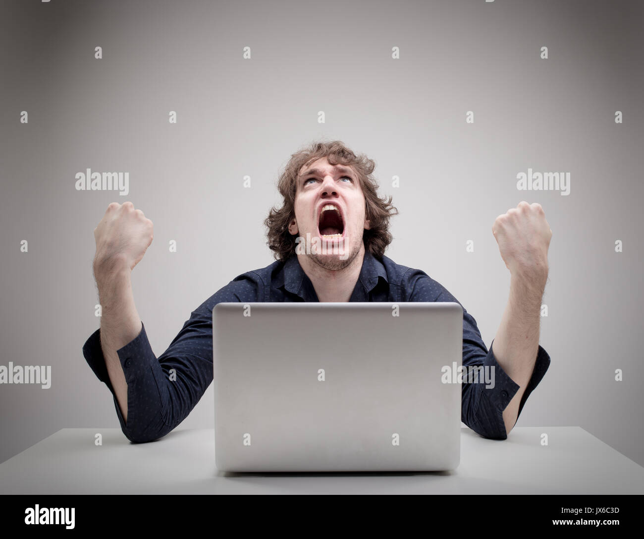 angry man swearing and cursing against information technology and his ...