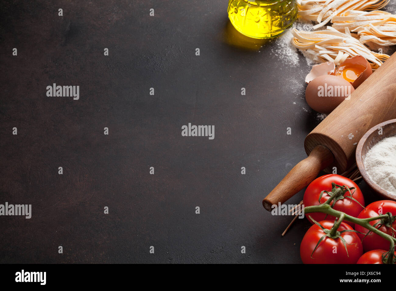Pasta cooking ingredients on wooden kitchen table. With space for your ...