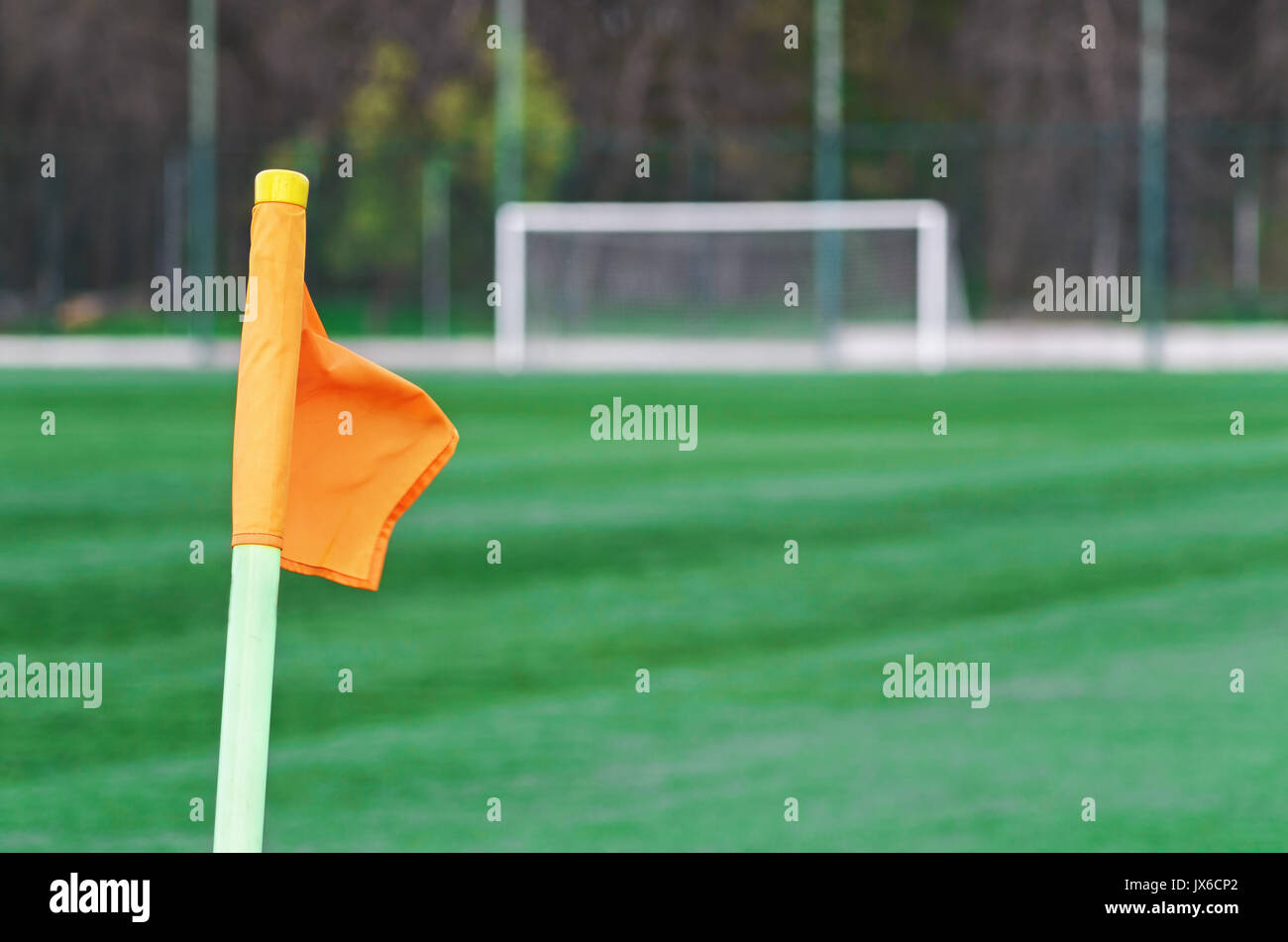 Corner flag of a soccer field. Orange flag in corner of football ...