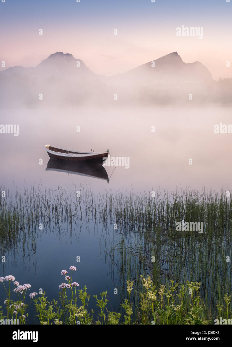 Very peaceful summer night with wooden boat and fog in Lofoten, Norway ...