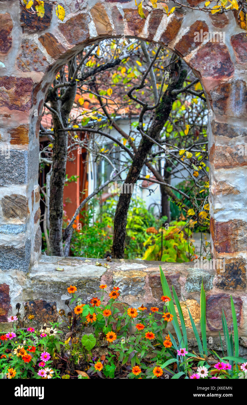 Stylish stone wall and colorful flowers Stock Photo - Alamy