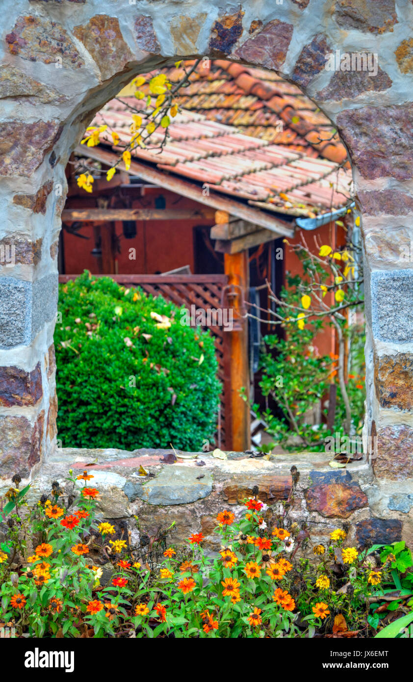 Stylish stone wall and colorful flowers Stock Photo - Alamy