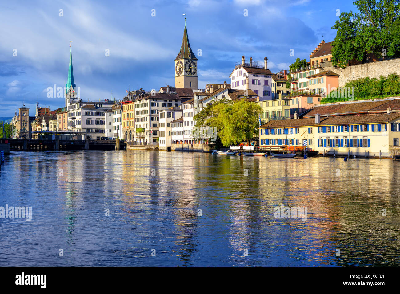 Old town of Zurich with iconic Clock Tower reflecting in Limmat river ...