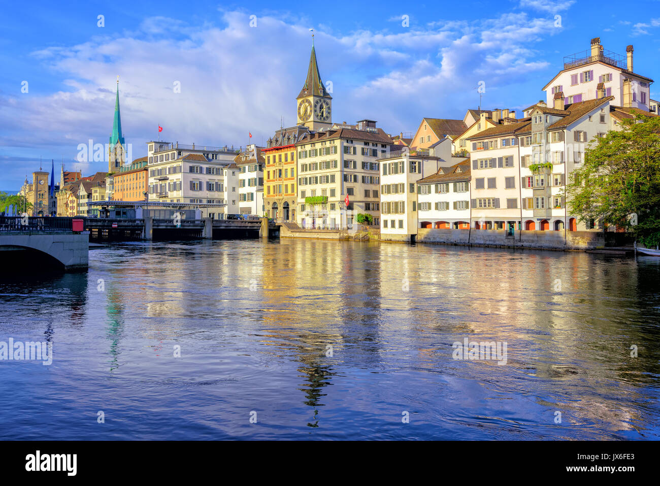 Old town of Zurich with iconic Clock Tower reflecting in Limmat river ...