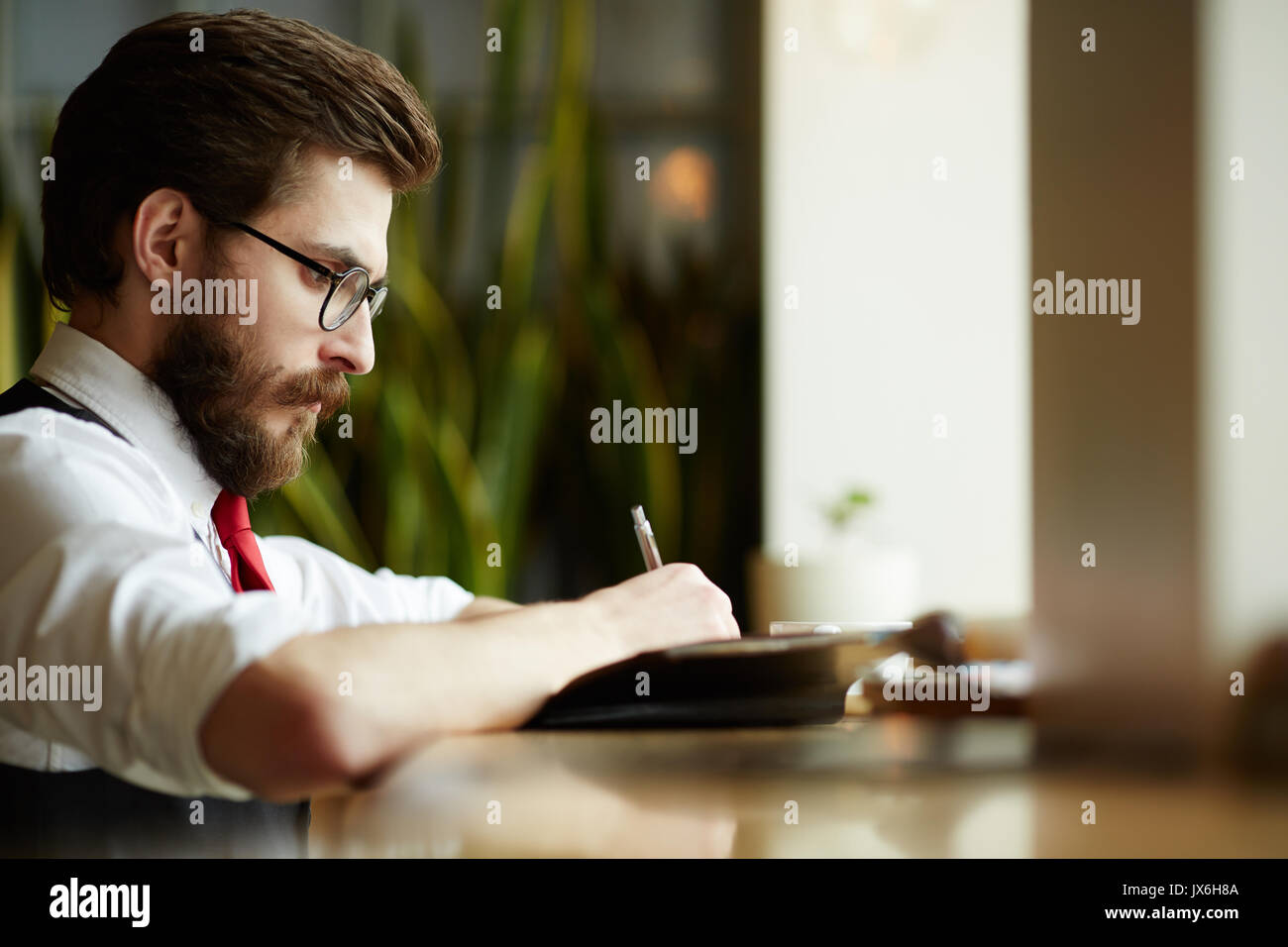 Writing in diary Stock Photo - Alamy